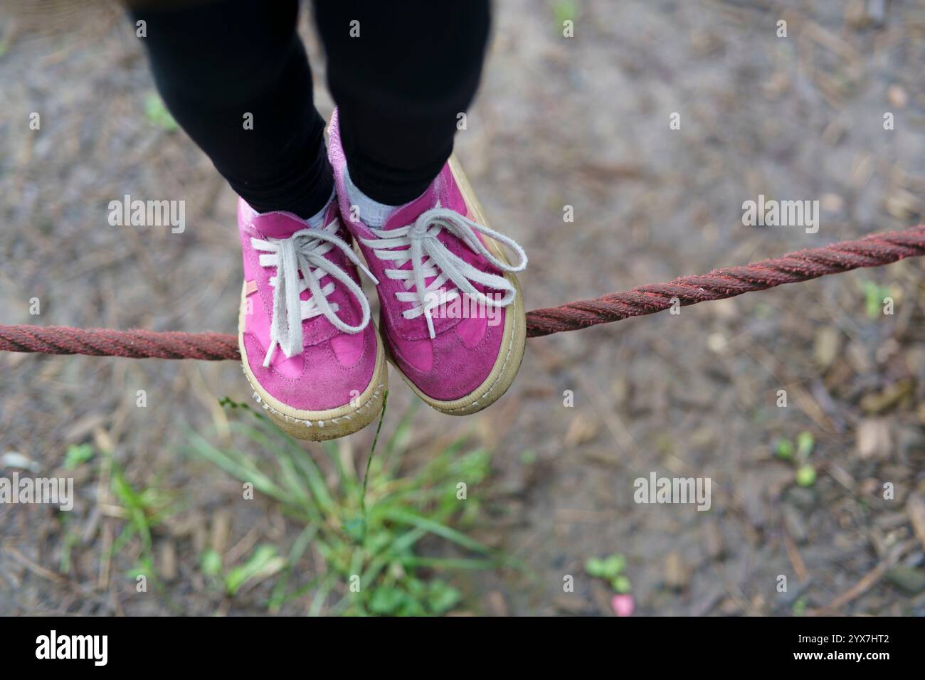 Children's legs balance on a rope. Children's feet in shoes close-up ...