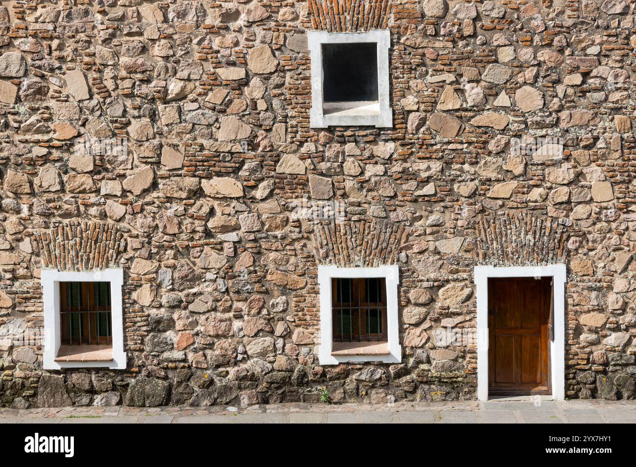 Stone and brick wall with a door and three windows. Jesus María ...