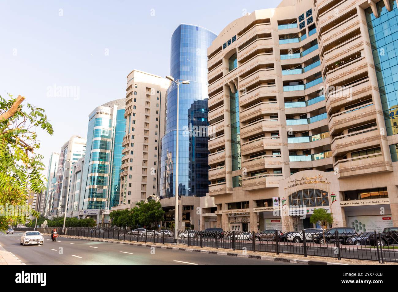 A view of modern high-rise buildings with glass facades lining a city ...