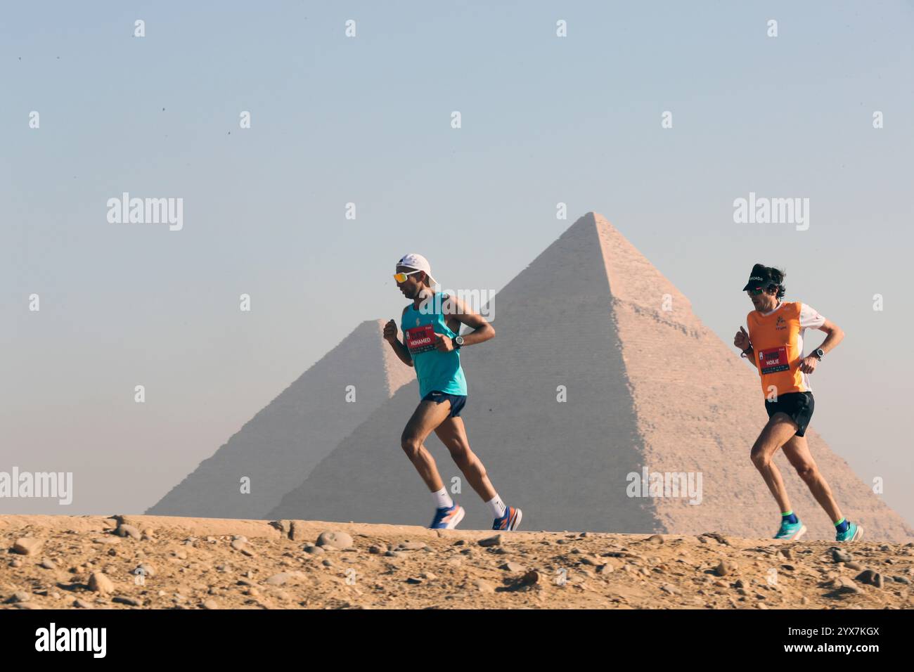 Participants run during the 5th edition of the Pyramids Half Marathon at Great Pyramids of Giza ...