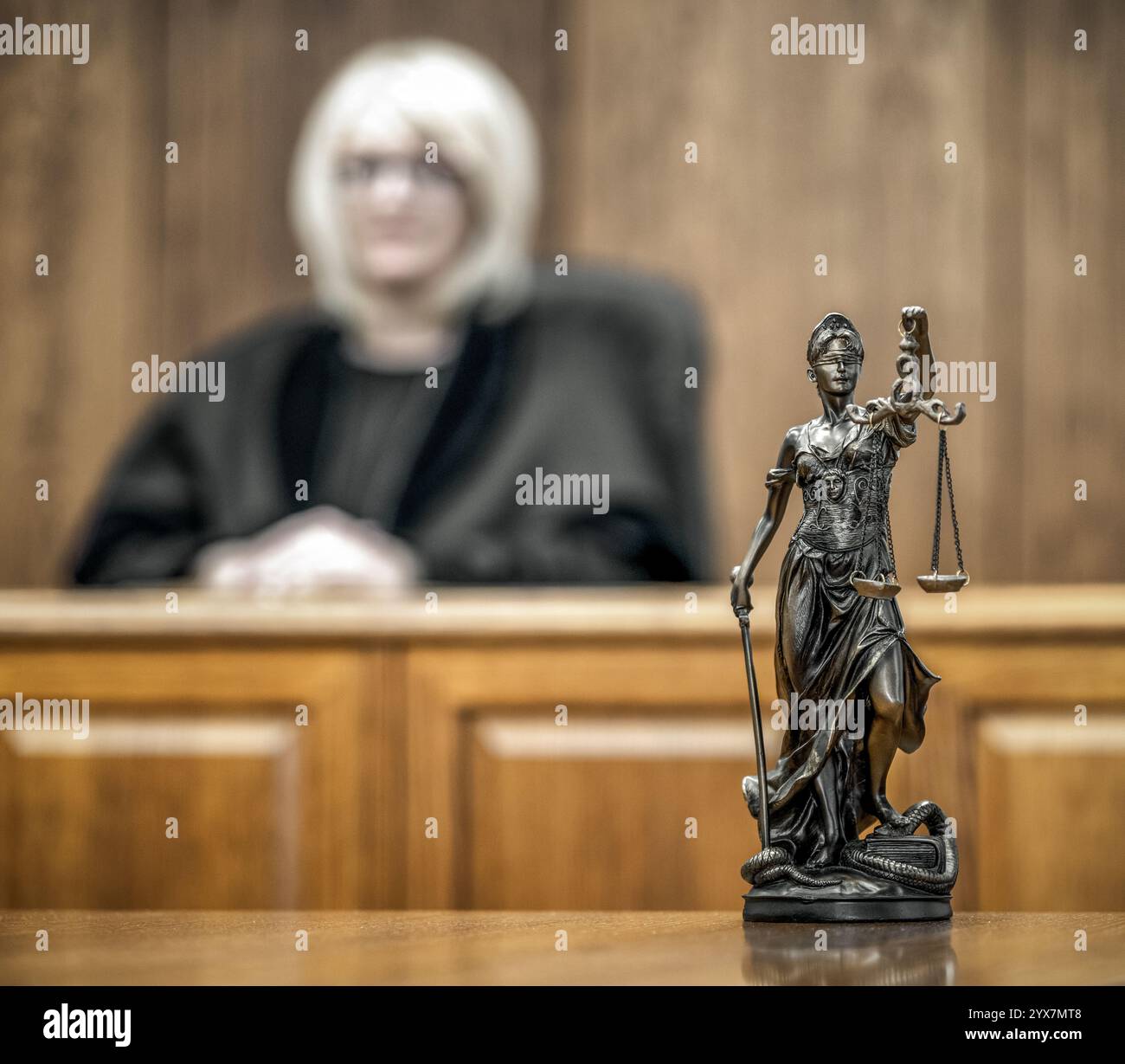 Statue of justice and judge robe in background. Lady Lustitia in ...