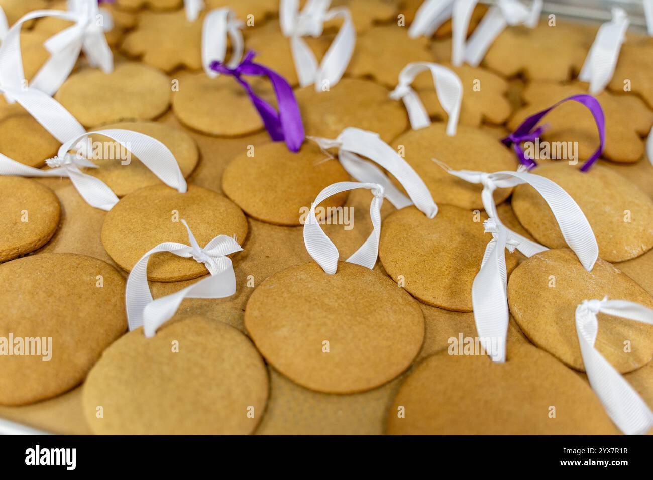 Lots of gingerbread cookies with ribbons are ready to decorate ...