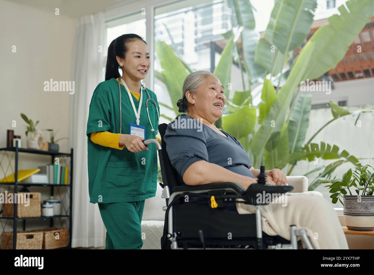 Nurse Caring About Woman With Disability At Home Stock Photo - Alamy