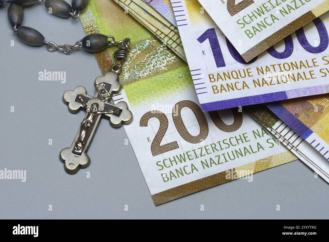 Crucifix and banknotes, Swiss francs, church and money Stock Photo - Alamy