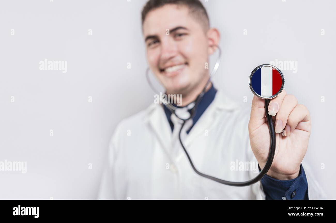 Smiling doctor showing stethoscope with France flag. France National ...