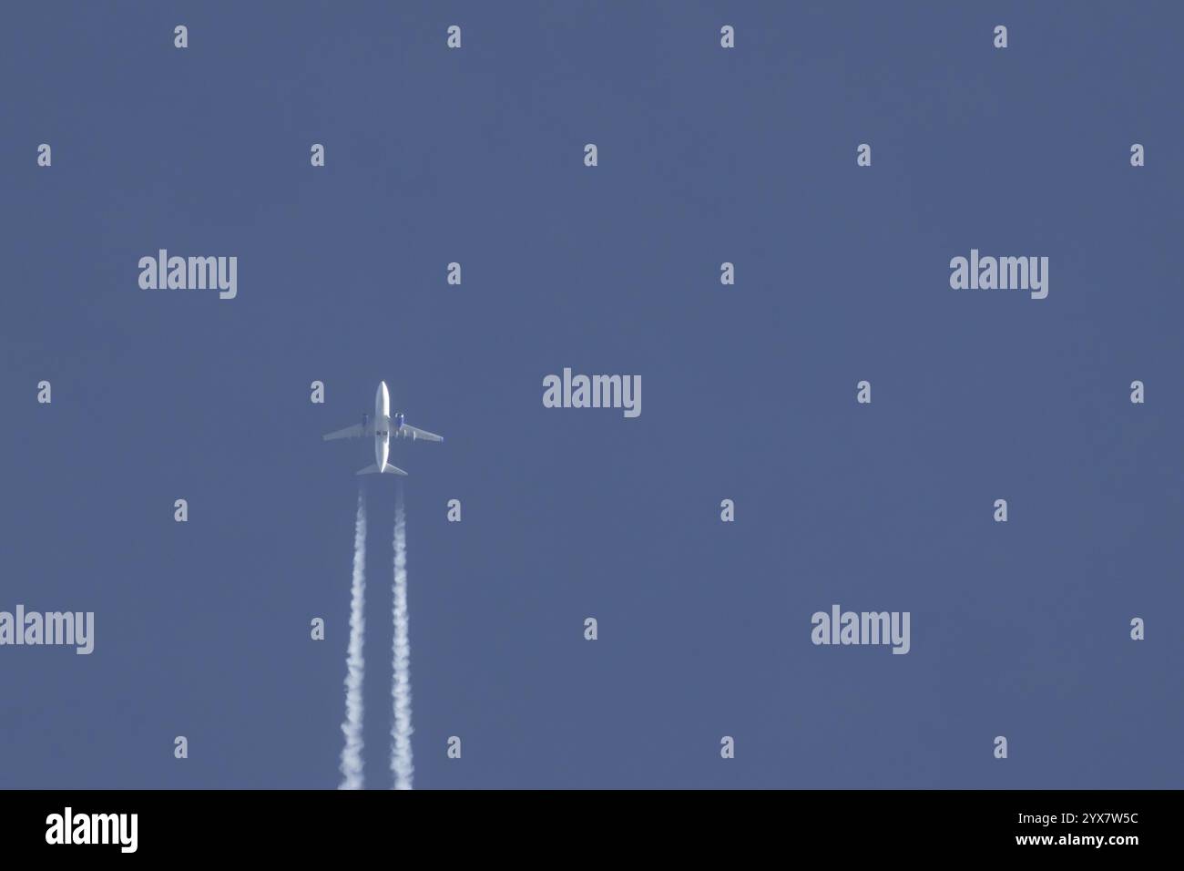 Boeing 737 jet passanger aircraft of flying in a blue sky with vapor ...
