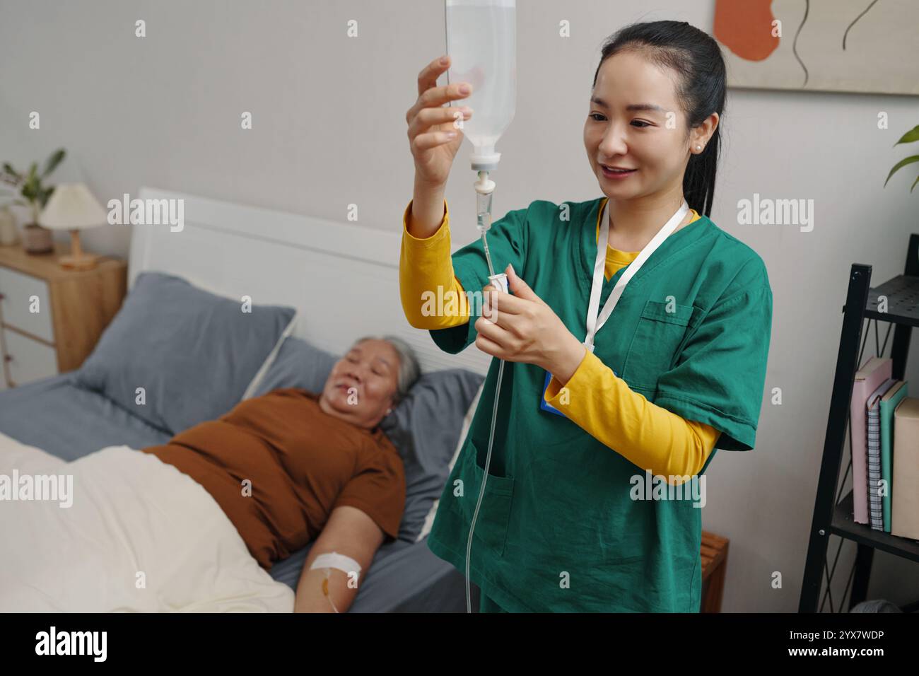 Nurse Putting An IV Drip On Woman Stock Photo - Alamy