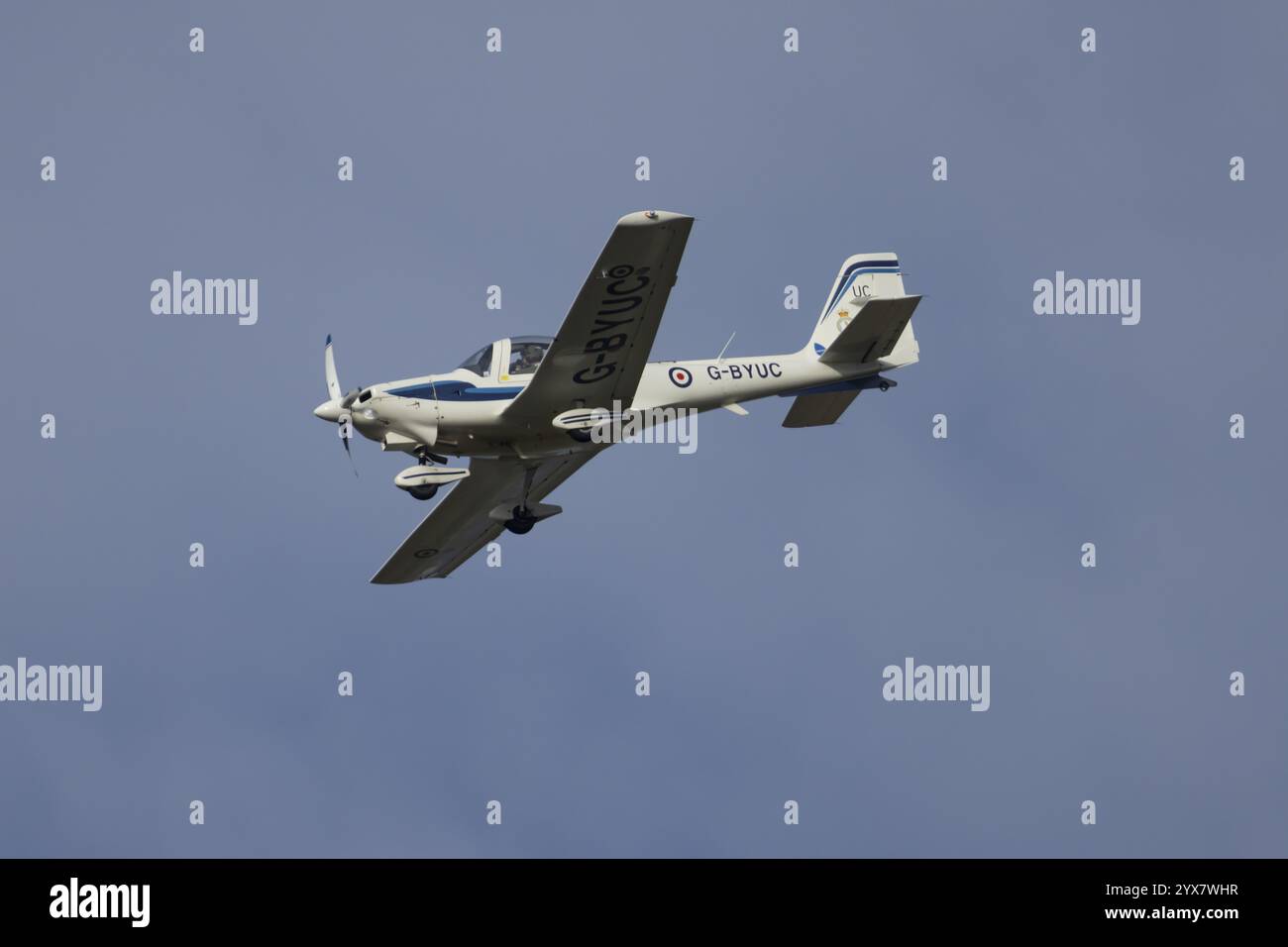 Grob G115E Tutor aircraft flying in a blue sky, England, United Kingdom ...