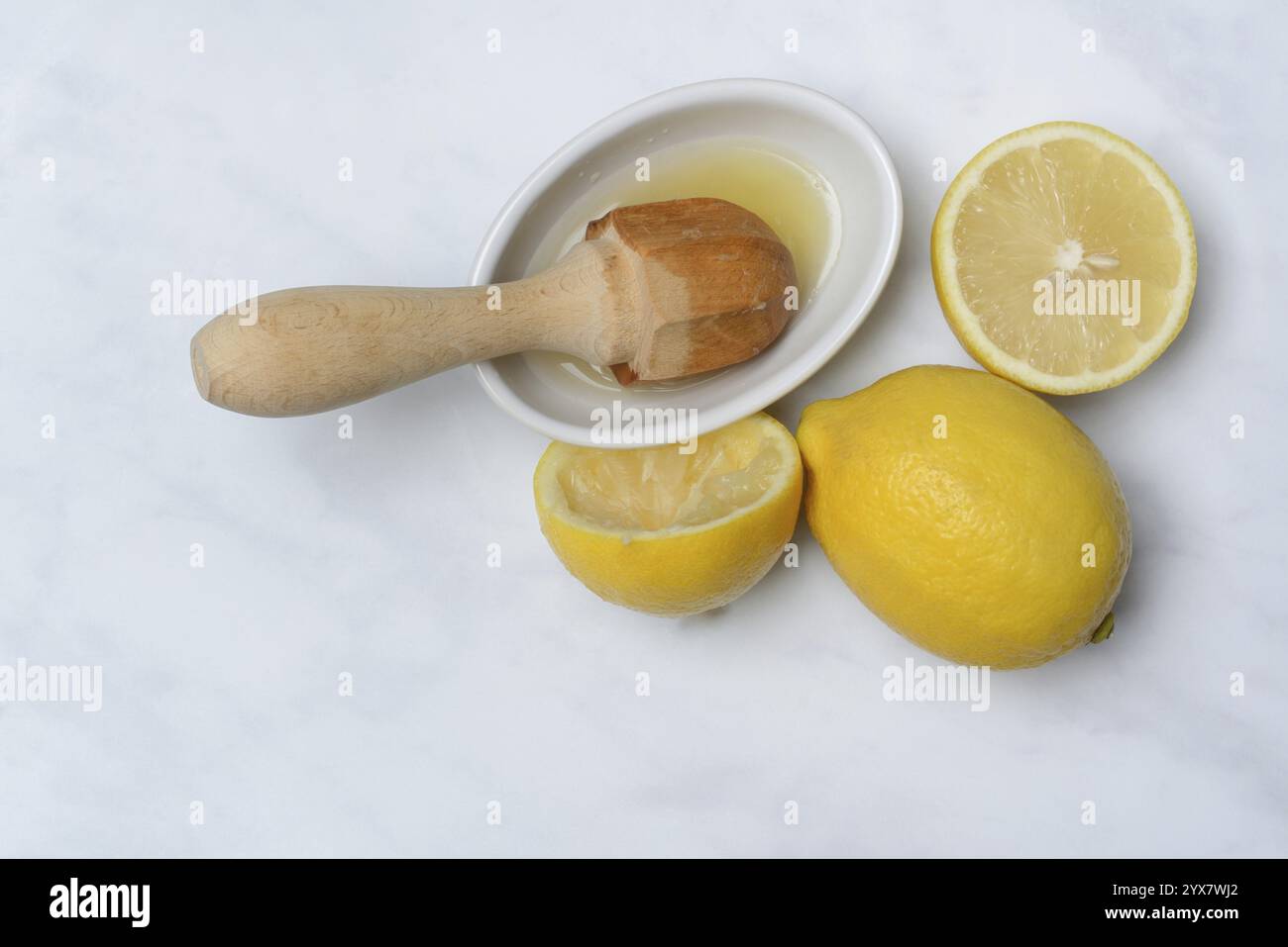 Lemons and lemon squeezer, squeezed lemon and lemon juice Stock Photo ...