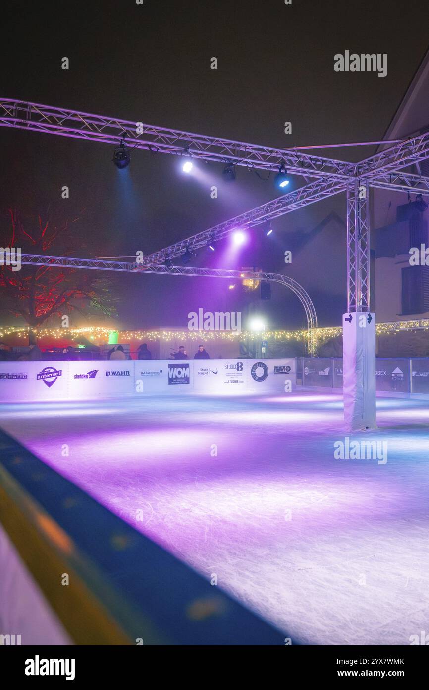 Vacant ice rink in a night-time atmosphere with purple lighting and ...