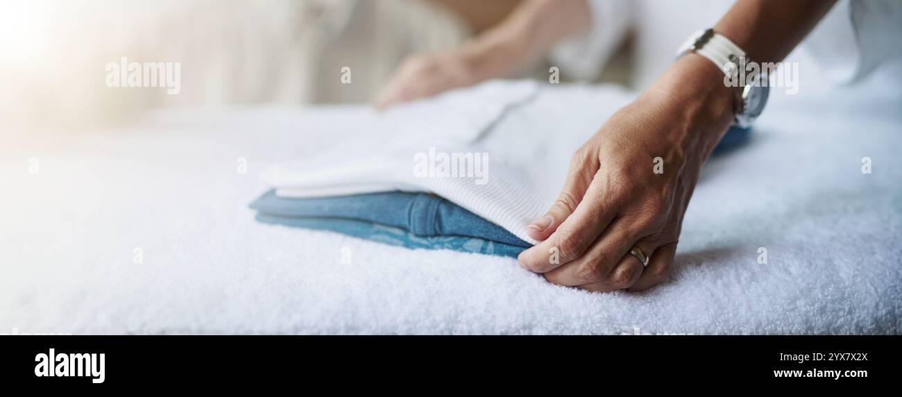 Person, hands and folding laundry in home for housekeeping, chores and ...