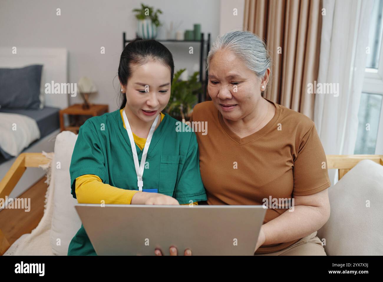 Caregiver Learning Old Woman To Use Computer Stock Photo - Alamy