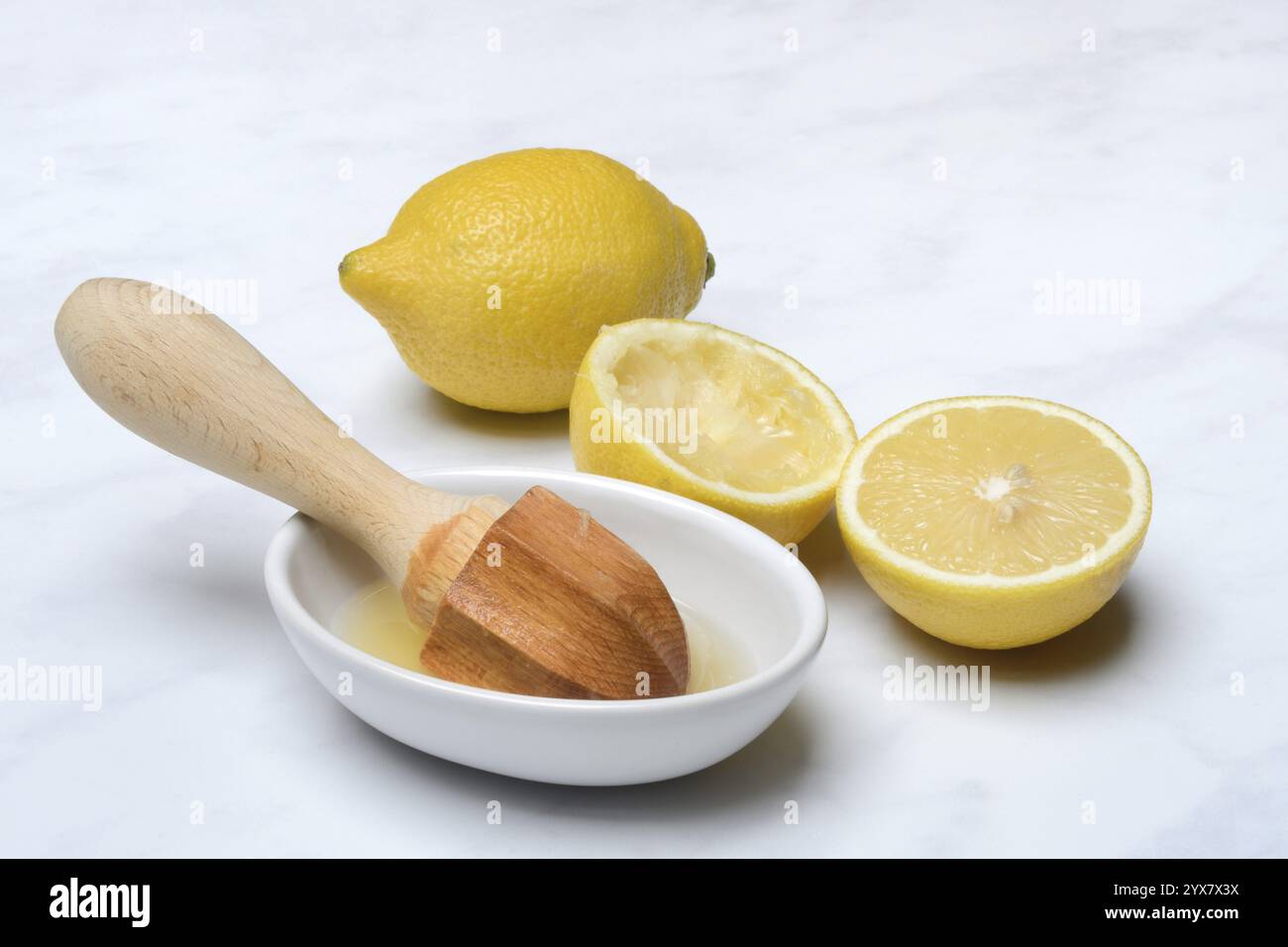 Lemons and lemon squeezer, squeezed lemon and lemon juice Stock Photo ...