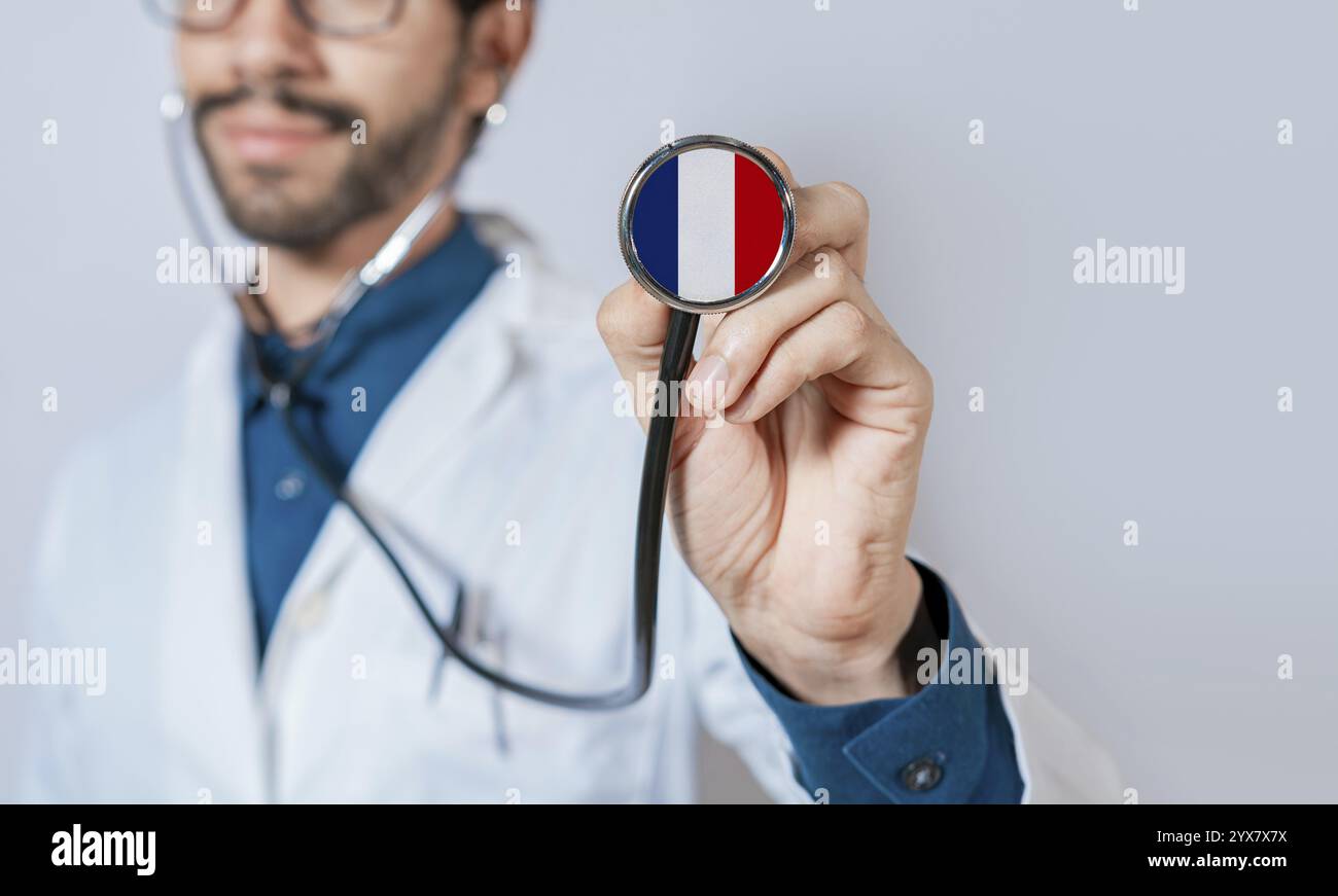 Doctor holding stethoscope with France flag. French Health and Care ...