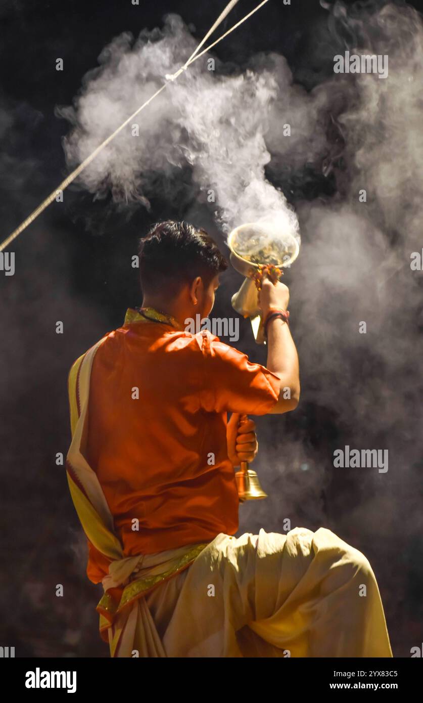 Pujaris or Indian priests performing Aarti ceremony on banks of Ganges ...
