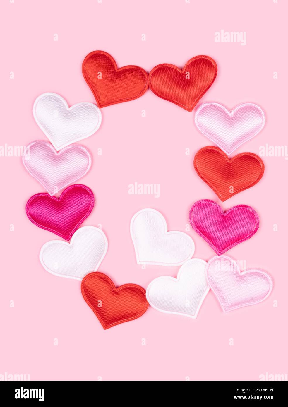 Letter Q made of glossy atlas hearts isolated on solid pink background ...