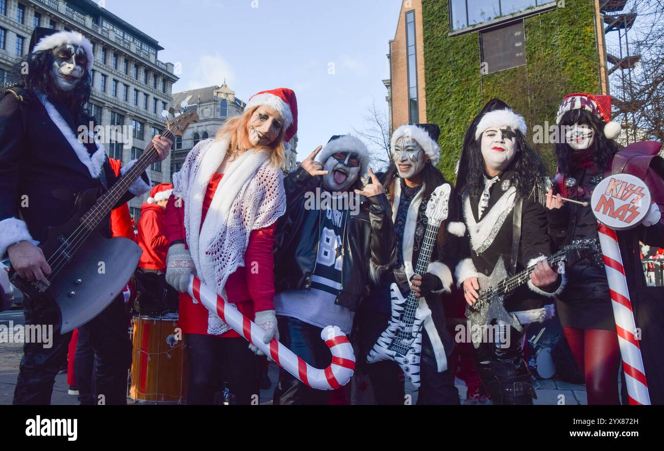 London, UK. 14th December 2024. Revellers dressed as rock band KISS ...