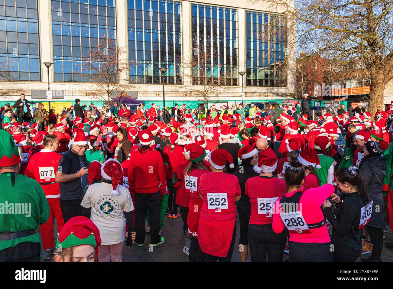 Some of the more than 600 Santas gathered in Kings Square at the start ...