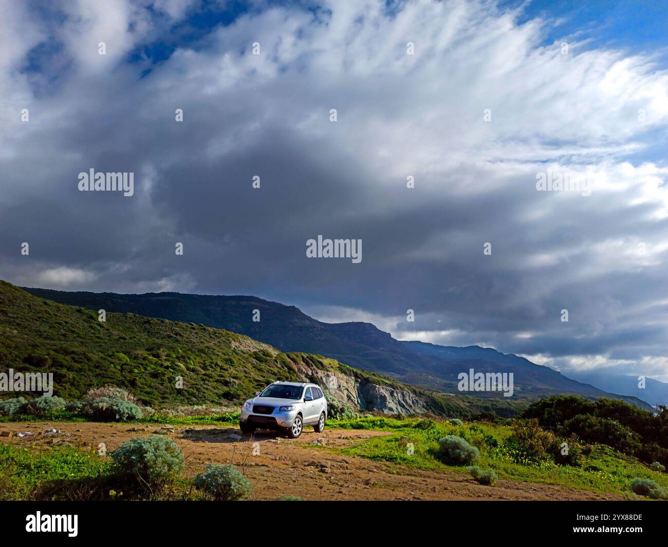 Car in the countryside under a huge grey cloud. Adventure concept Stock ...