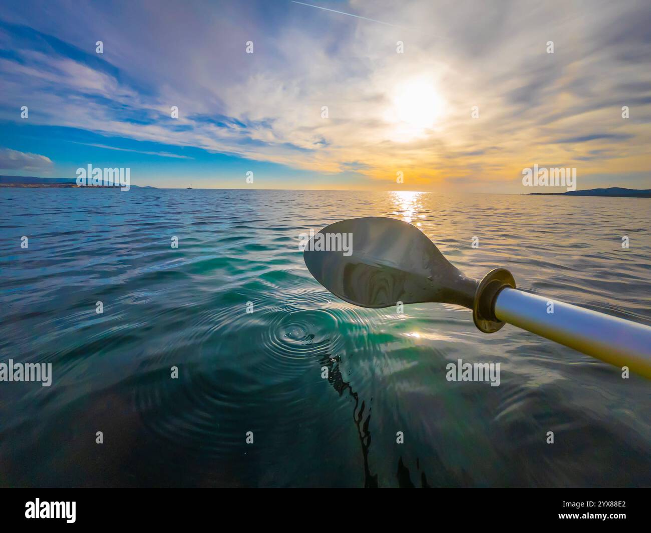 Kayak paddle over the water at sunset Stock Photo - Alamy