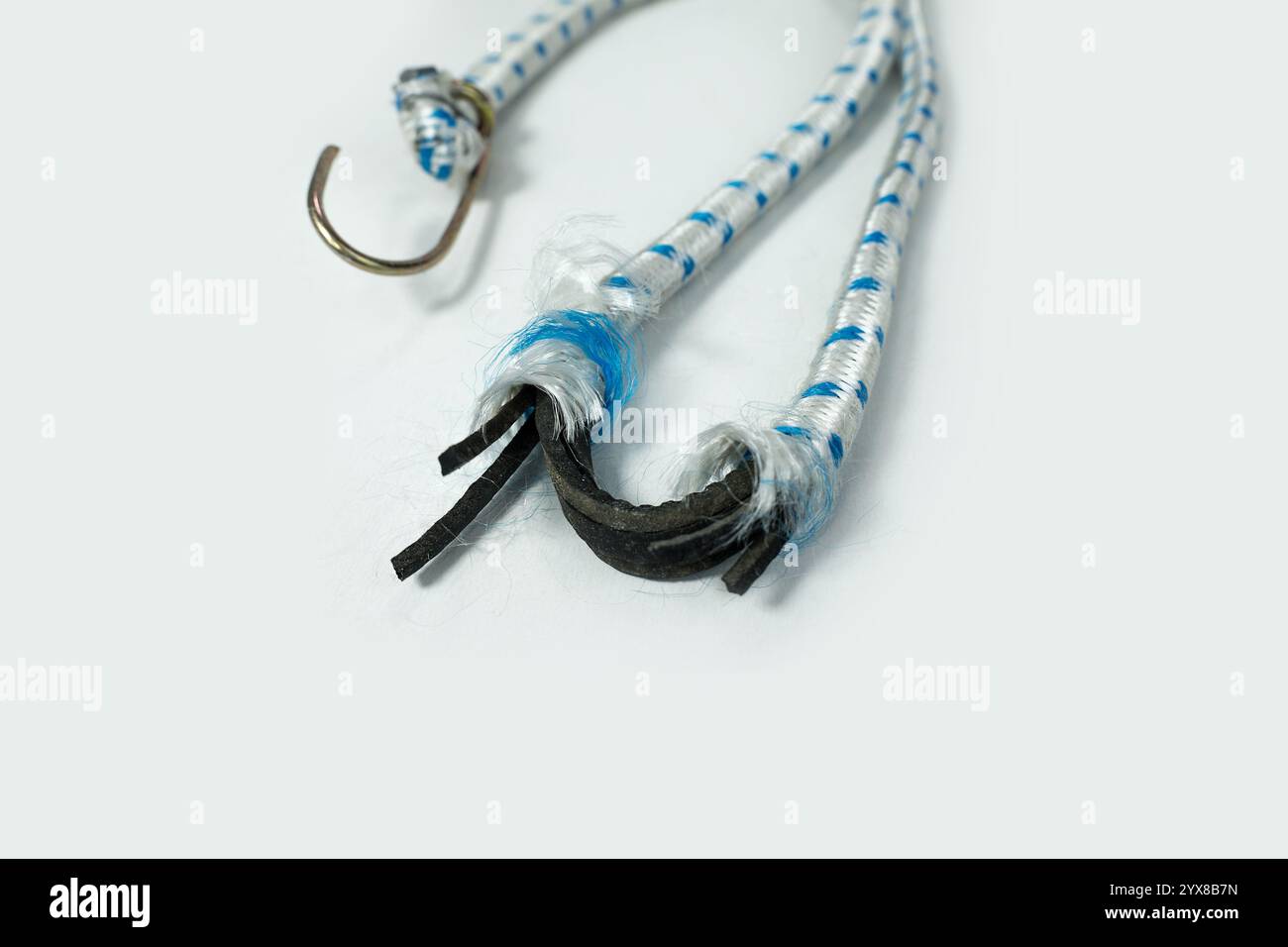 Broken Bungee rubber rope with hooks Stock Photo - Alamy