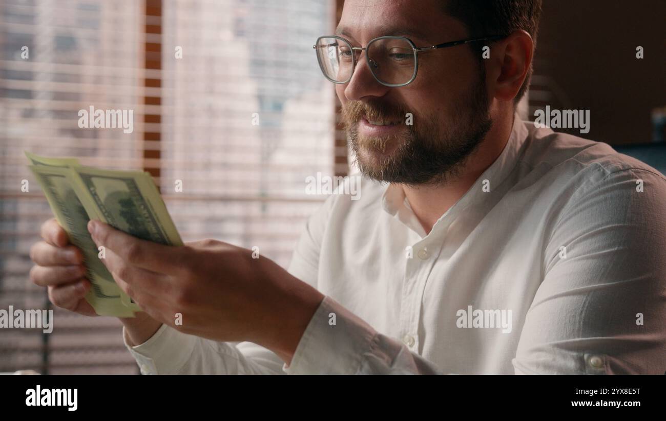Joyful Caucasian businessman guy trader executive boss counting money ...