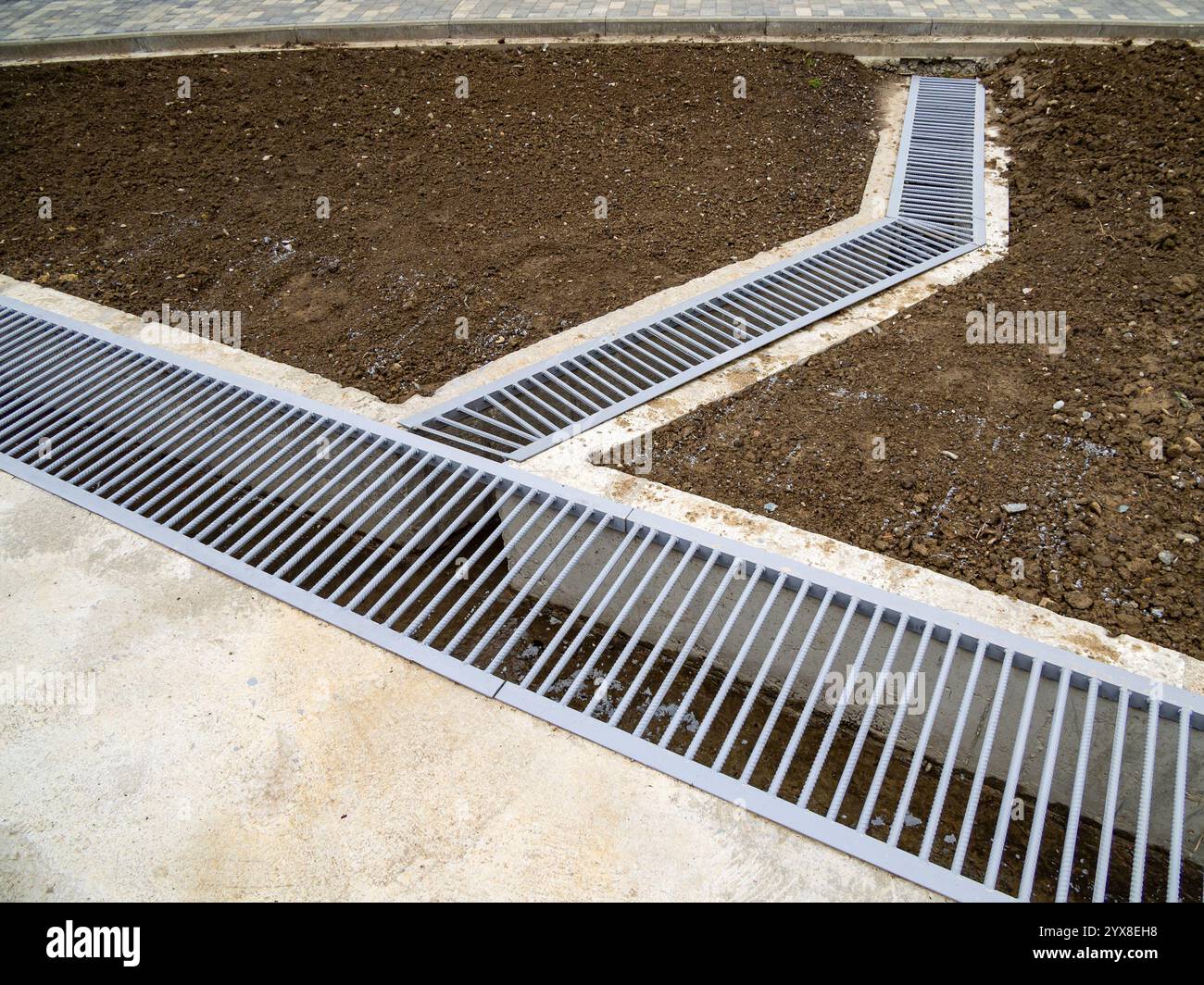 Drainage system ditch closed with welded grating Stock Photo - Alamy