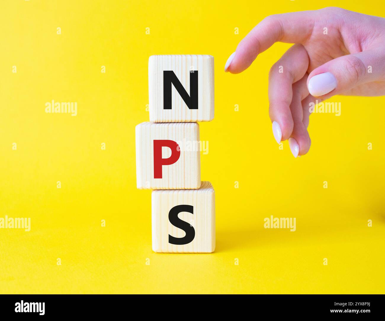 NPS - Net Promoter Score symbol. Wooden cubes with words NPS ...
