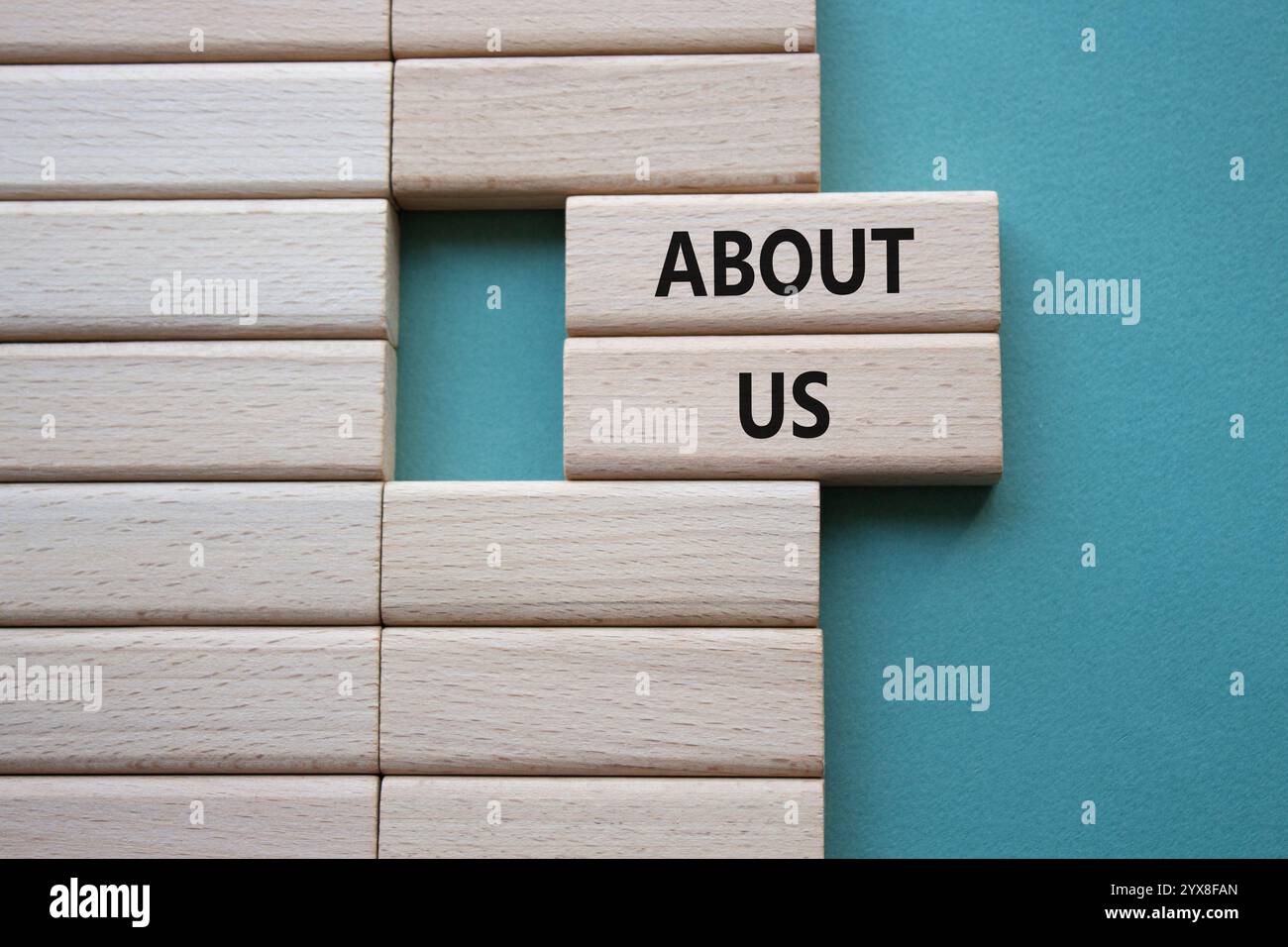 About us symbol. Concept word About us on wooden blocks. Beautiful grey green background ...