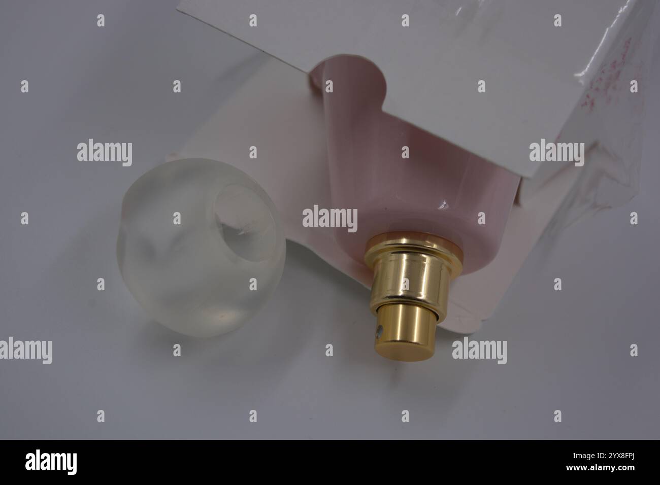 Objects, things, cosmetics and perfumes. A beautiful glass pink bottle ...