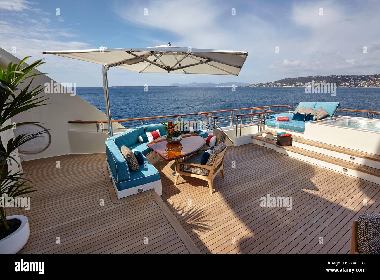 Elegant charter yacht deck featuring a stylish seating area, dining set ...