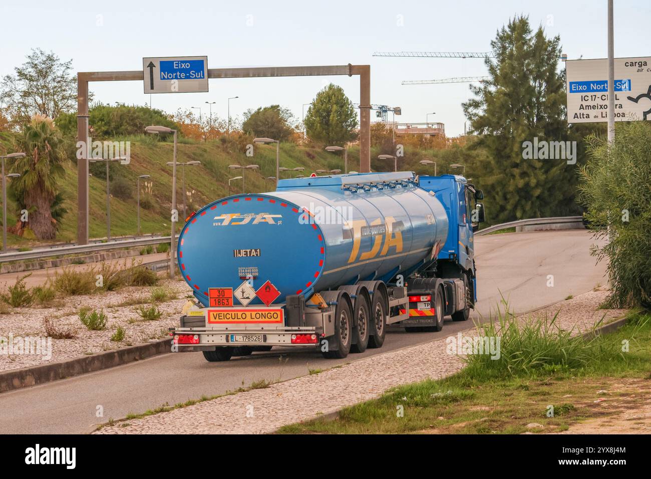 Blue tanker truck carrying dangerous goods driving on highway ...