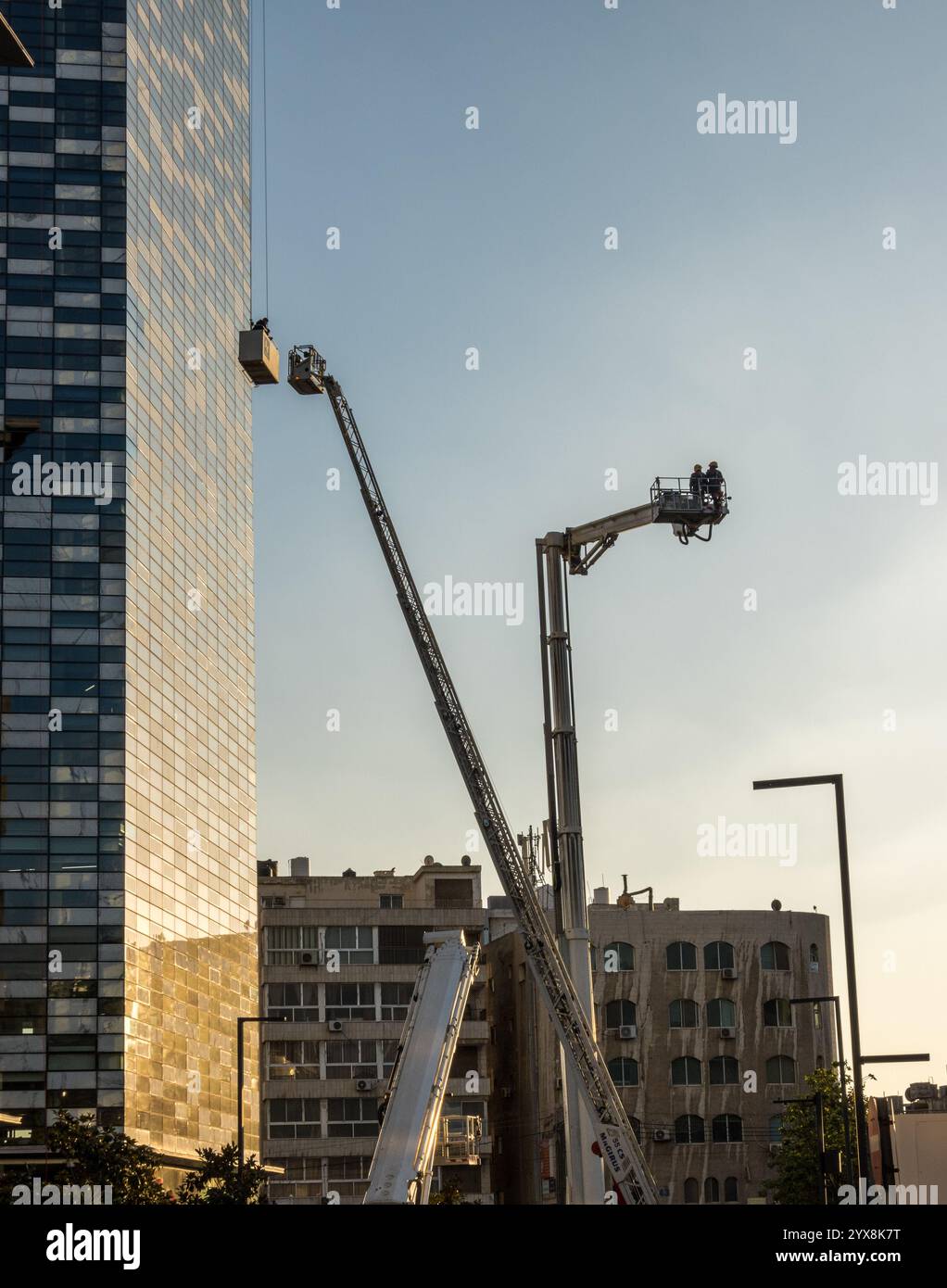 Firemen monitoring rescue from hoist during fire fighting emergency ...