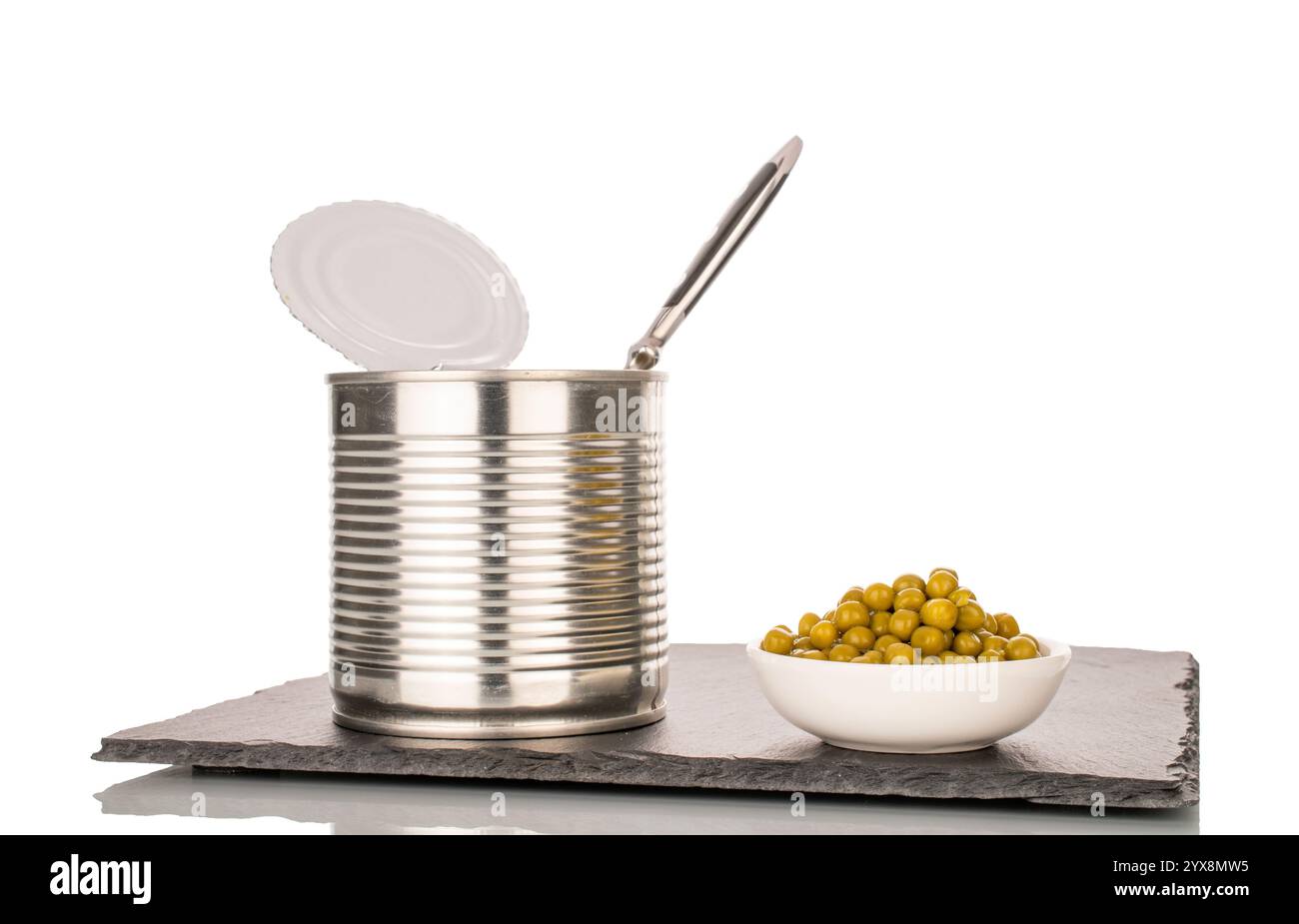 Canned green peas in a metal can, close-up, isolated on a white ...
