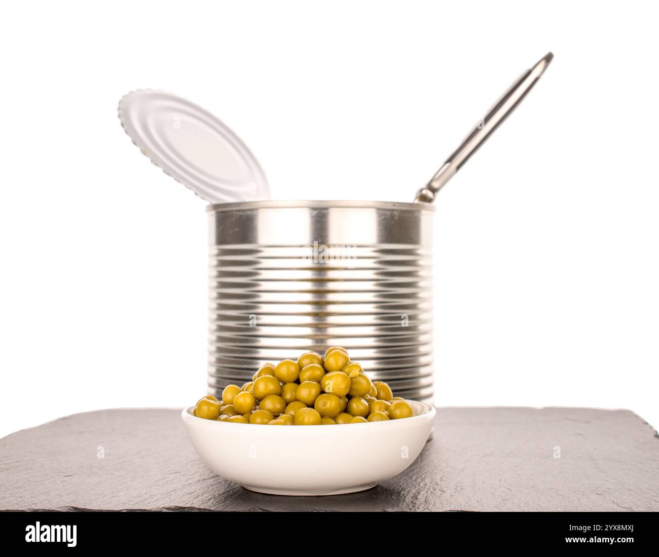 Canned green peas in a metal can, close-up, isolated on a white ...