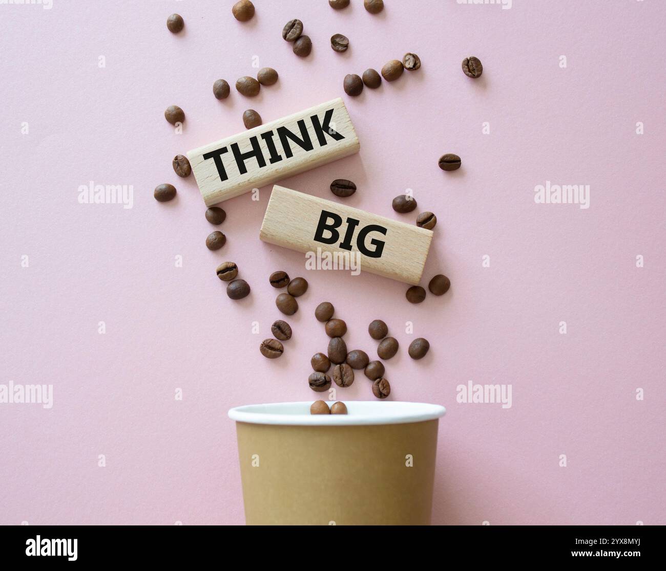 Think big symbol. Wooden blocks with words Think big. Beautiful pink ...
