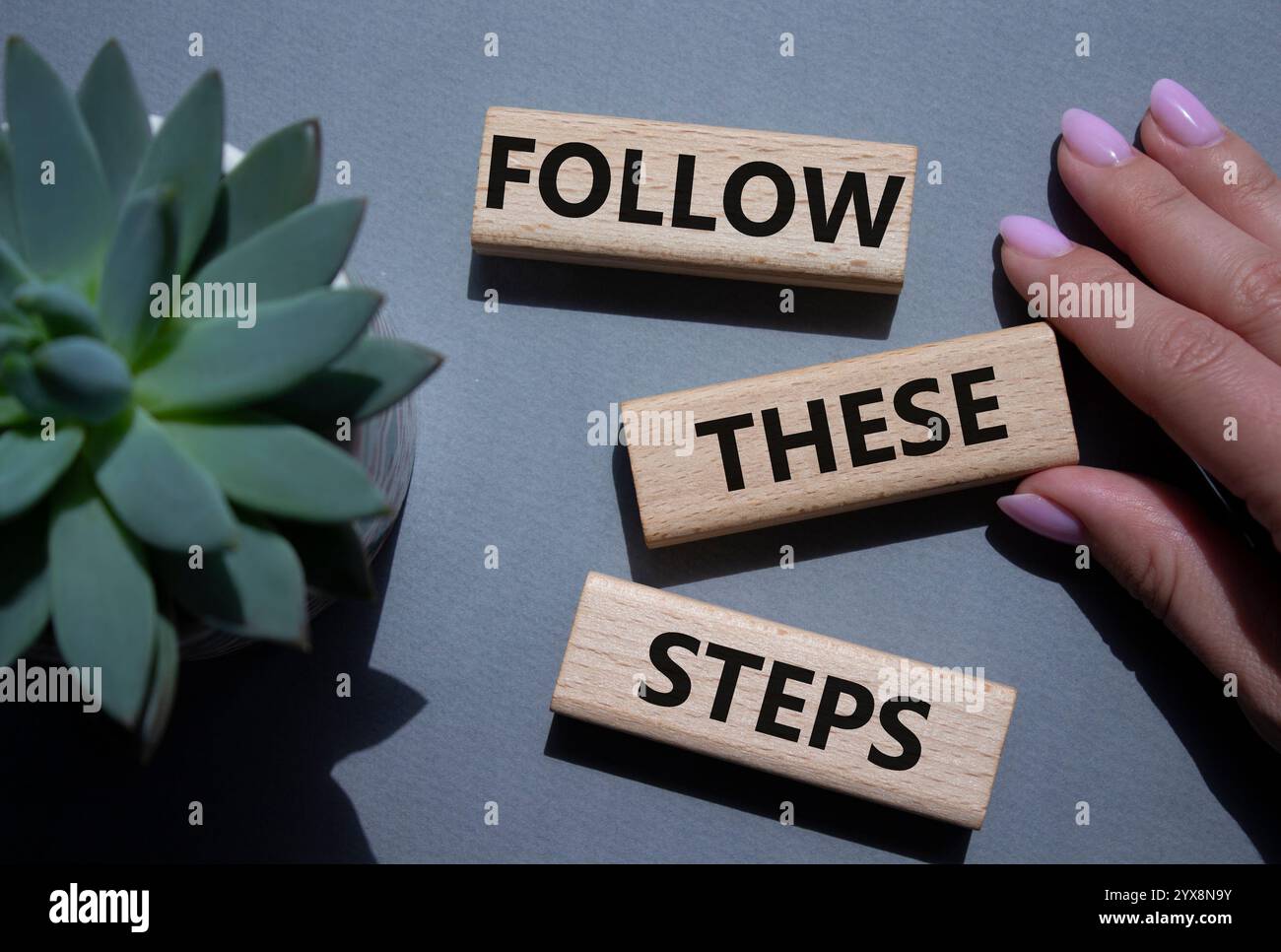 Follow these steps symbol. Wooden blocks with words Follow these steps ...