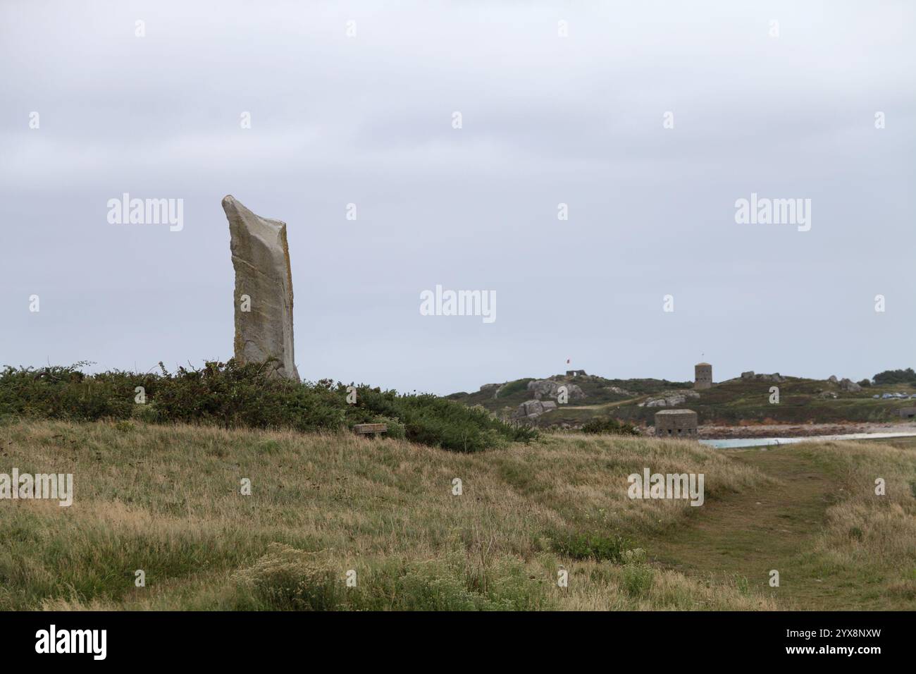 Millennium stone under a grey sky in a Neolithic landscape, L'Ancresse ...