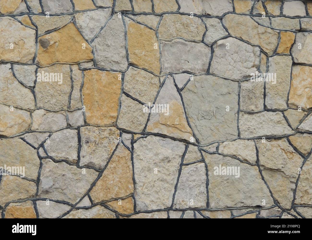 cladding the surface with decorative stone of abstract shape of gray ...
