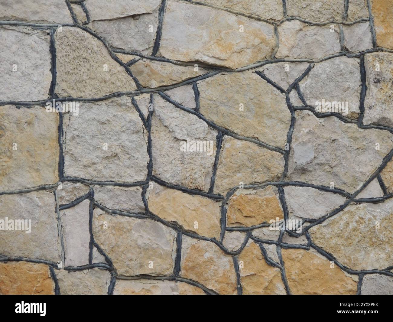 abstraction from facing stone of brown shades with black joints ...