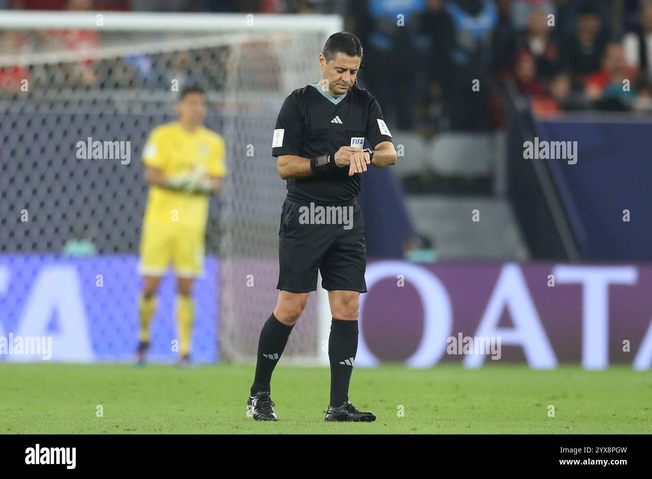Referee Alireza Faghani checks his watch during the Intercontinental ...