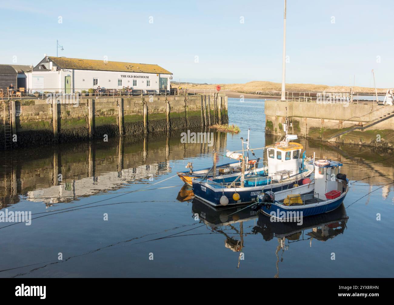 Fishing boats moored in Amble harbour, Northumberland, England, UK ...