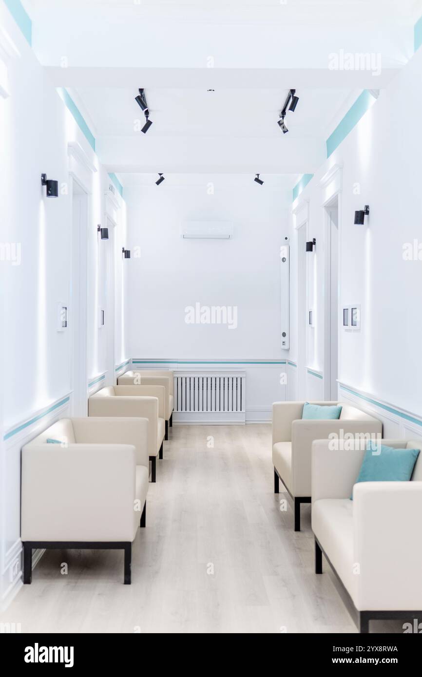 Modern waiting room with beige armchairs, light blue accents, and white ...