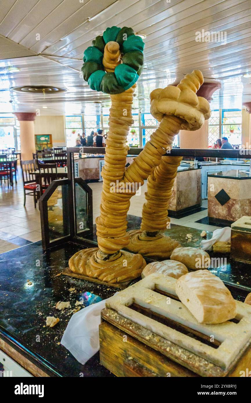A large bread sculpture is on display in a restaurant. The sculpture is ...