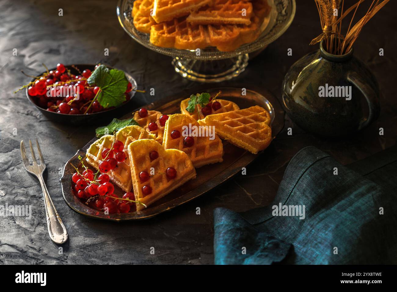 Heart shape belgium waffles with red currant decorated on vintage plate ...