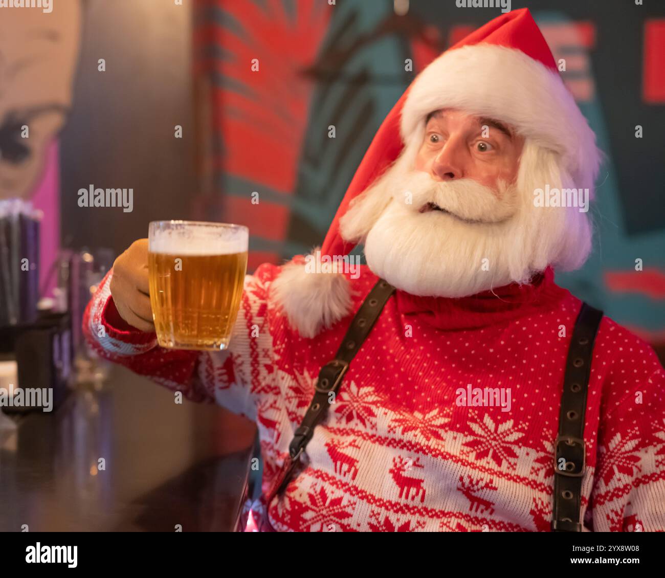 Santa Claus drinking beer at a bar Stock Photo - Alamy