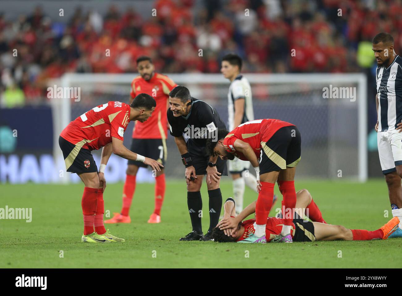 Al Ahly's Emam Ashour, left, talks with referee Alireza Faghani as ...