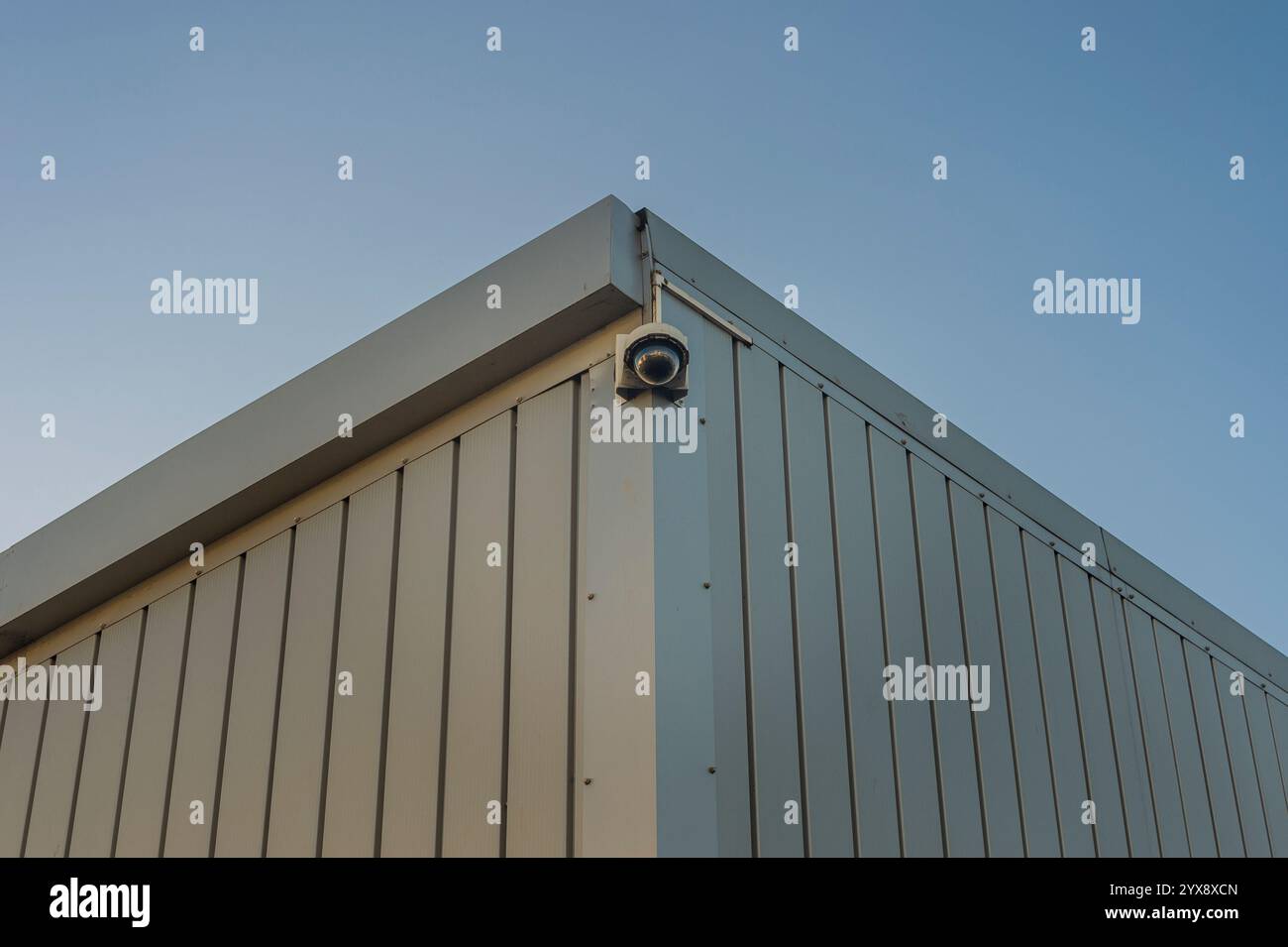 security camera on side of an industrial building Stock Photo - Alamy