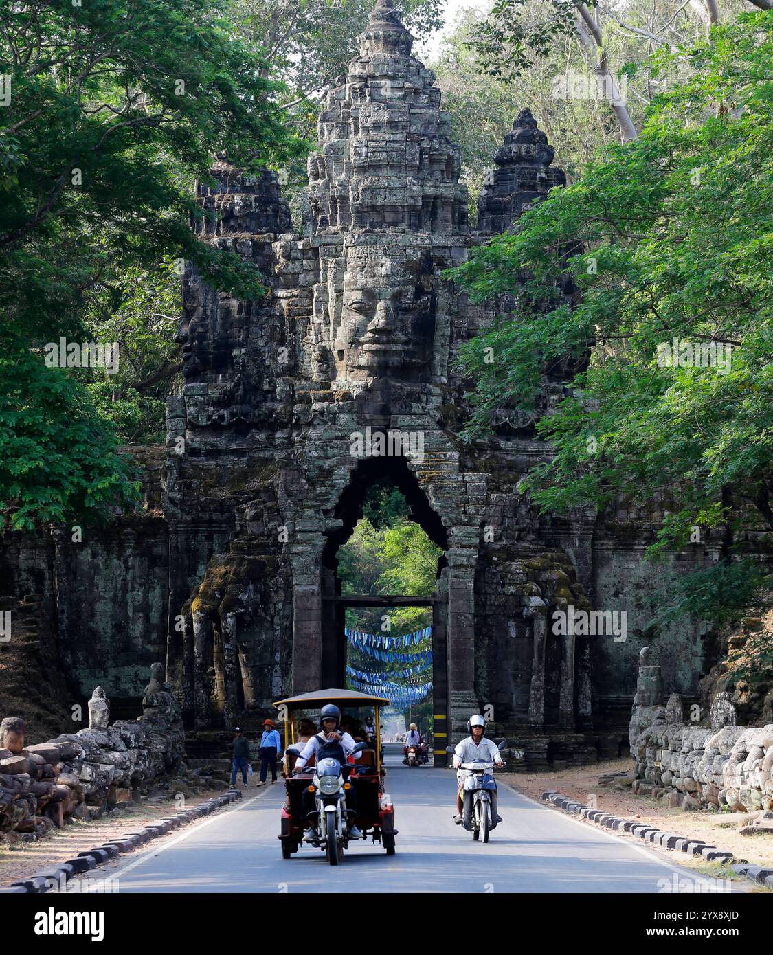 Siem Reap, Cambodia - April 2, 2023: People ride through North Gate of ...