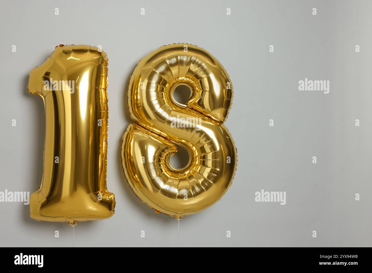 Coming of age party - 18th birthday. Number shaped balloons on light ...